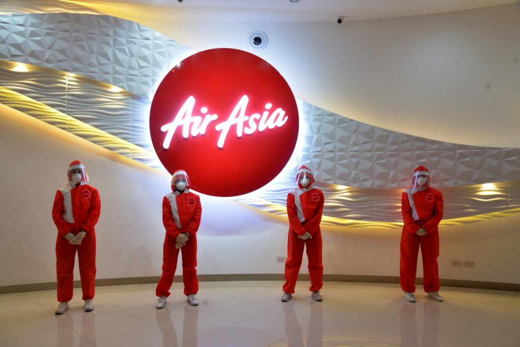 AirAsia's Iconic Uniforms Now Replaced with Red PPE Suits